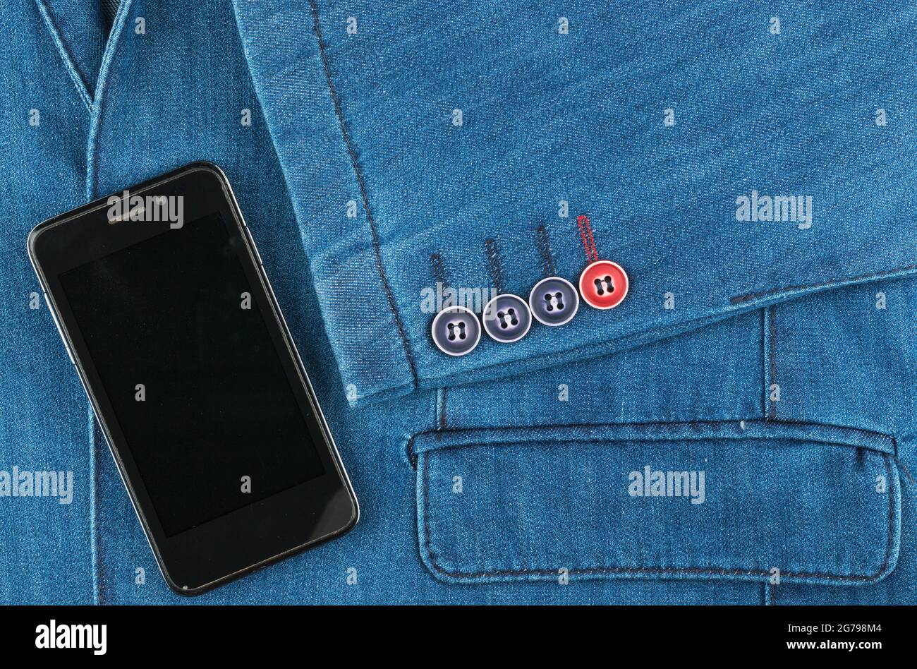Phone lying on a denim suit. Fashion background. Top view Stock Photo ...