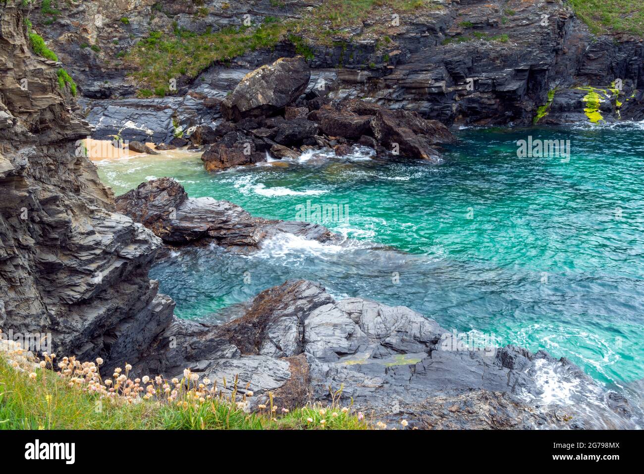 Cliffs and a small beach at Trevose head, Cornwall, UK. Turquoise blue ...