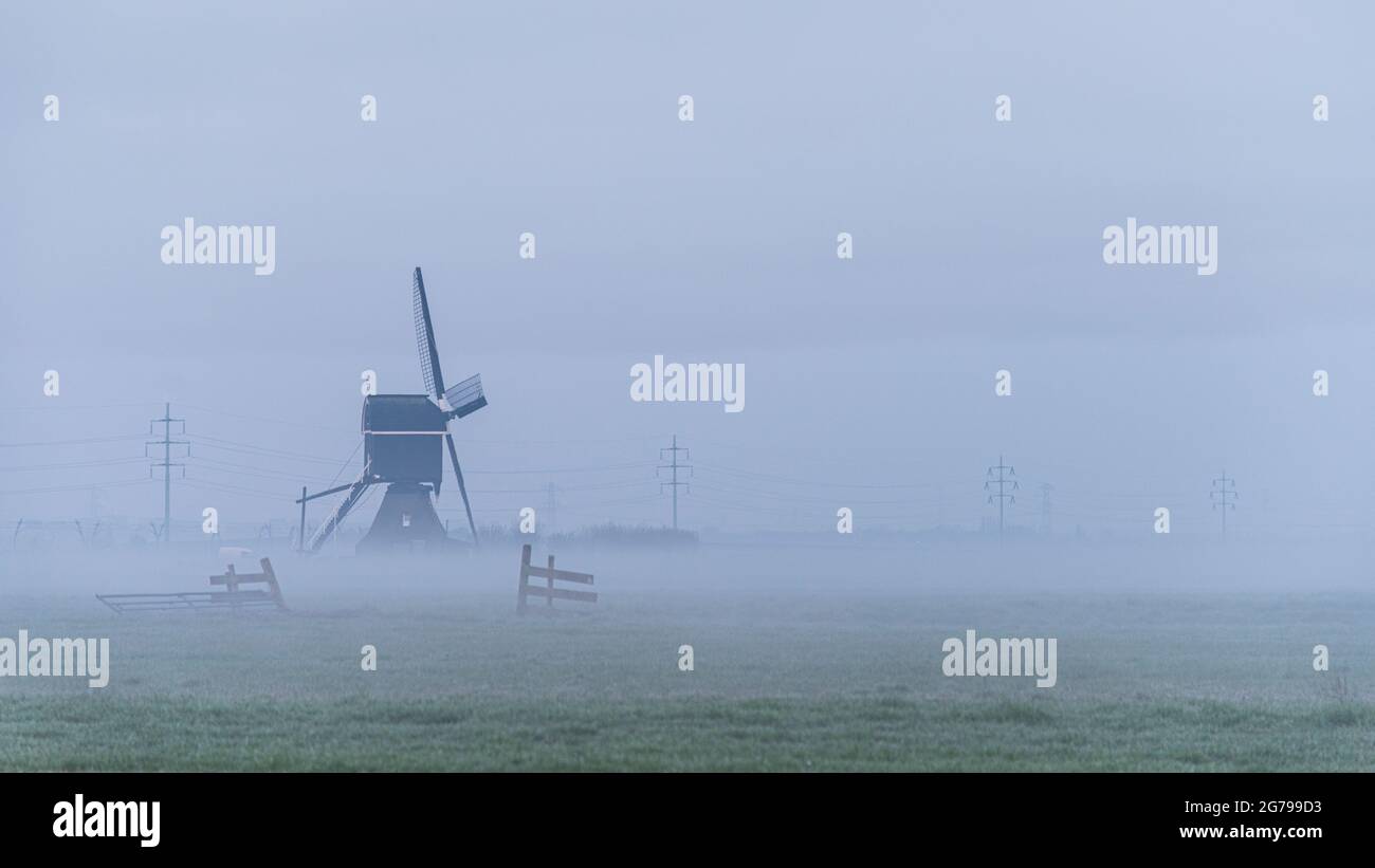Windmill and wooden fences in fog hi-res stock photography and images ...
