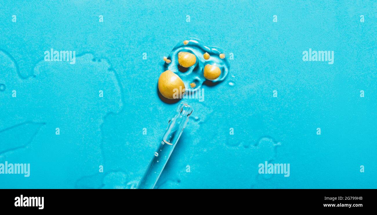 Pipette banner with cosmetic gel and gold drops on blue background ...