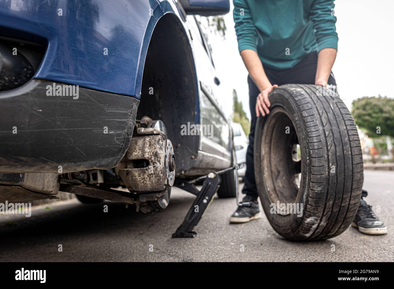 Mechanic screwing or unscrewing changing car wheel by wrench mechanic ...