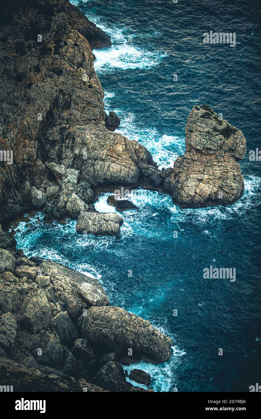 Rocks with blue water Stock Photo - Alamy