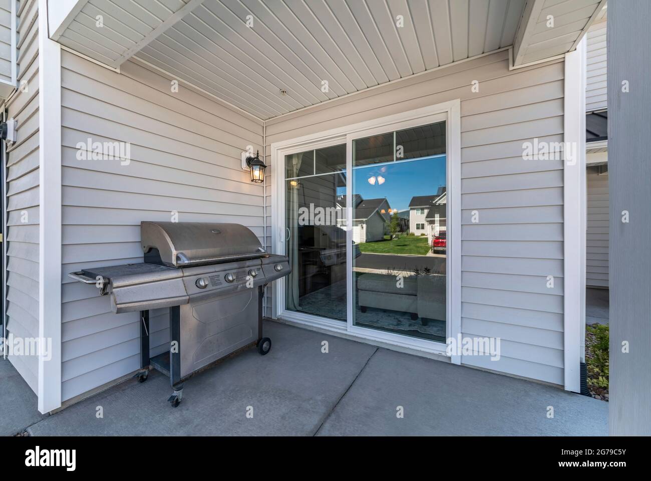 Exterior of a house with a sliding glass door and vinyl sidings Stock ...