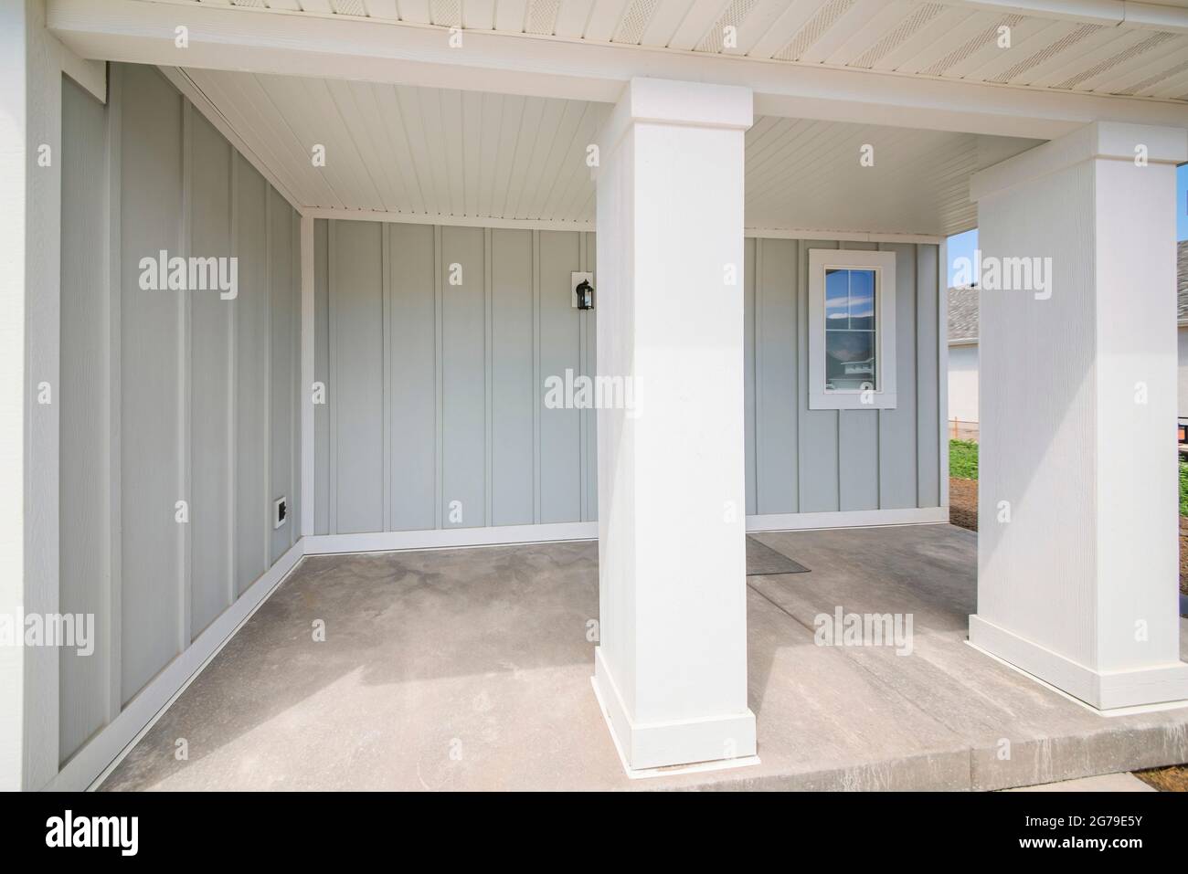 Exterior of a house with wood sidings and two white column posts Stock ...