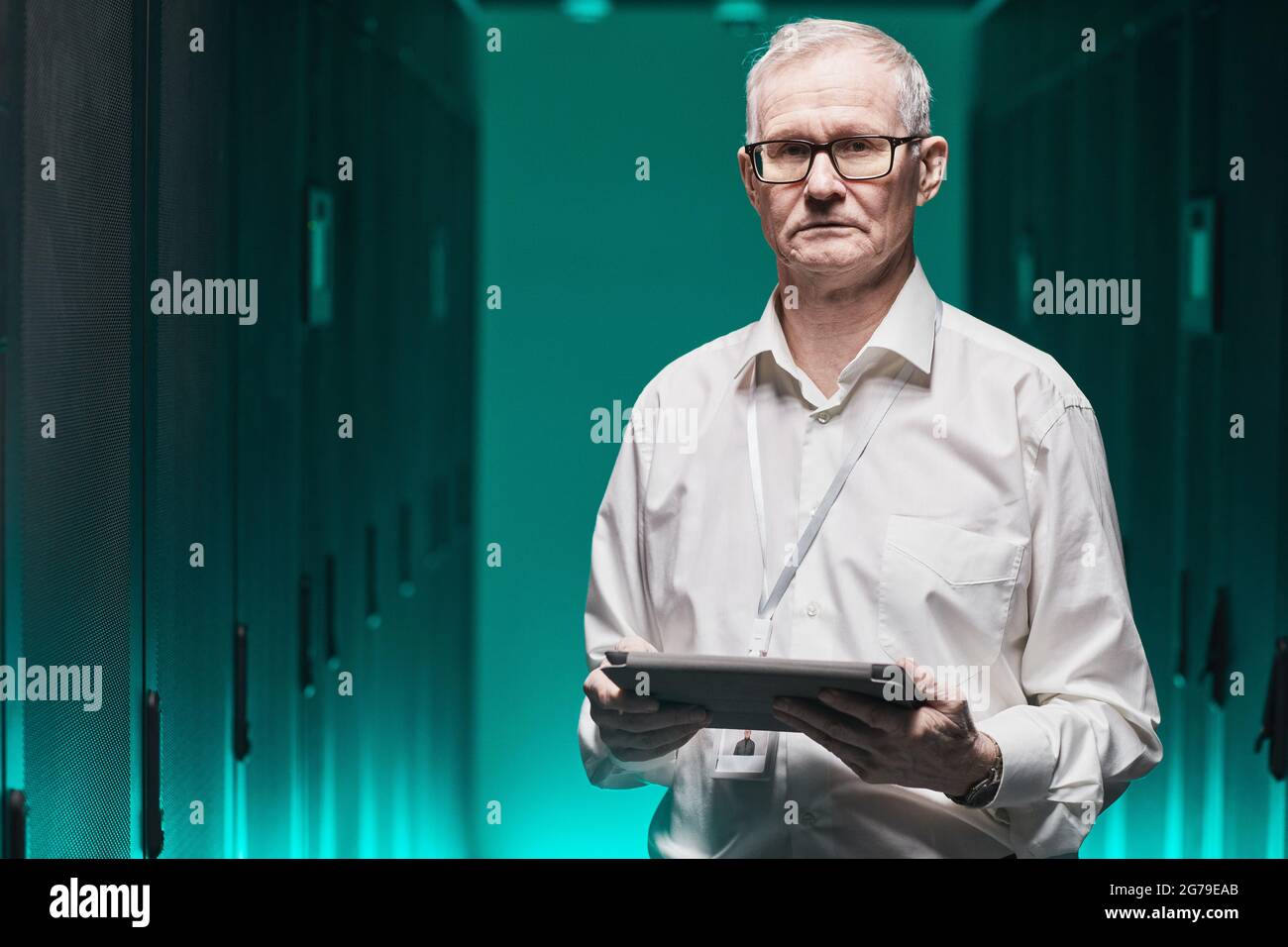 Waist up portrait of senior data scientist looking at camera and ...