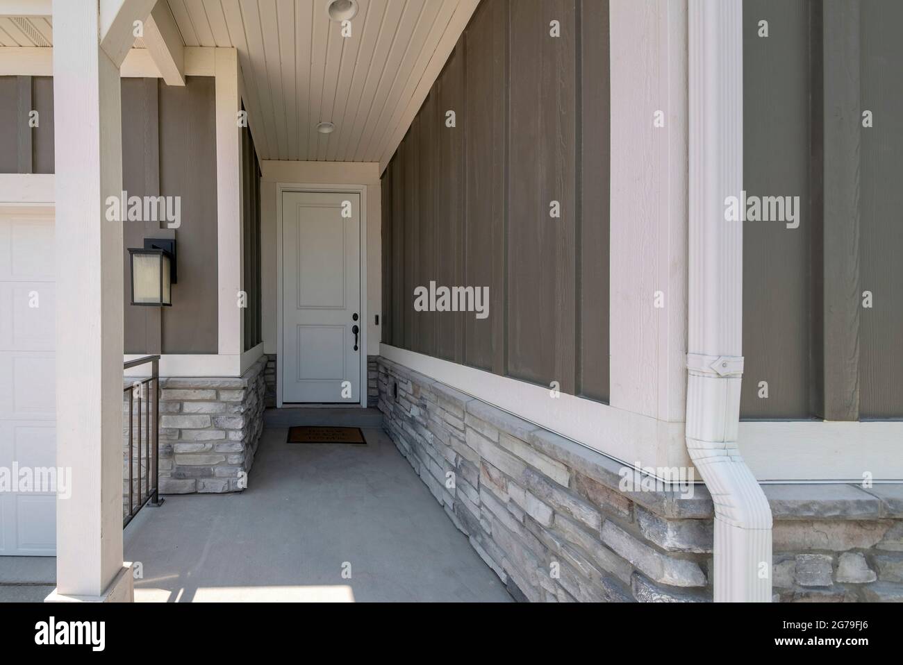 Front door corridor exterior with mocha wooden half wall and bricks ...
