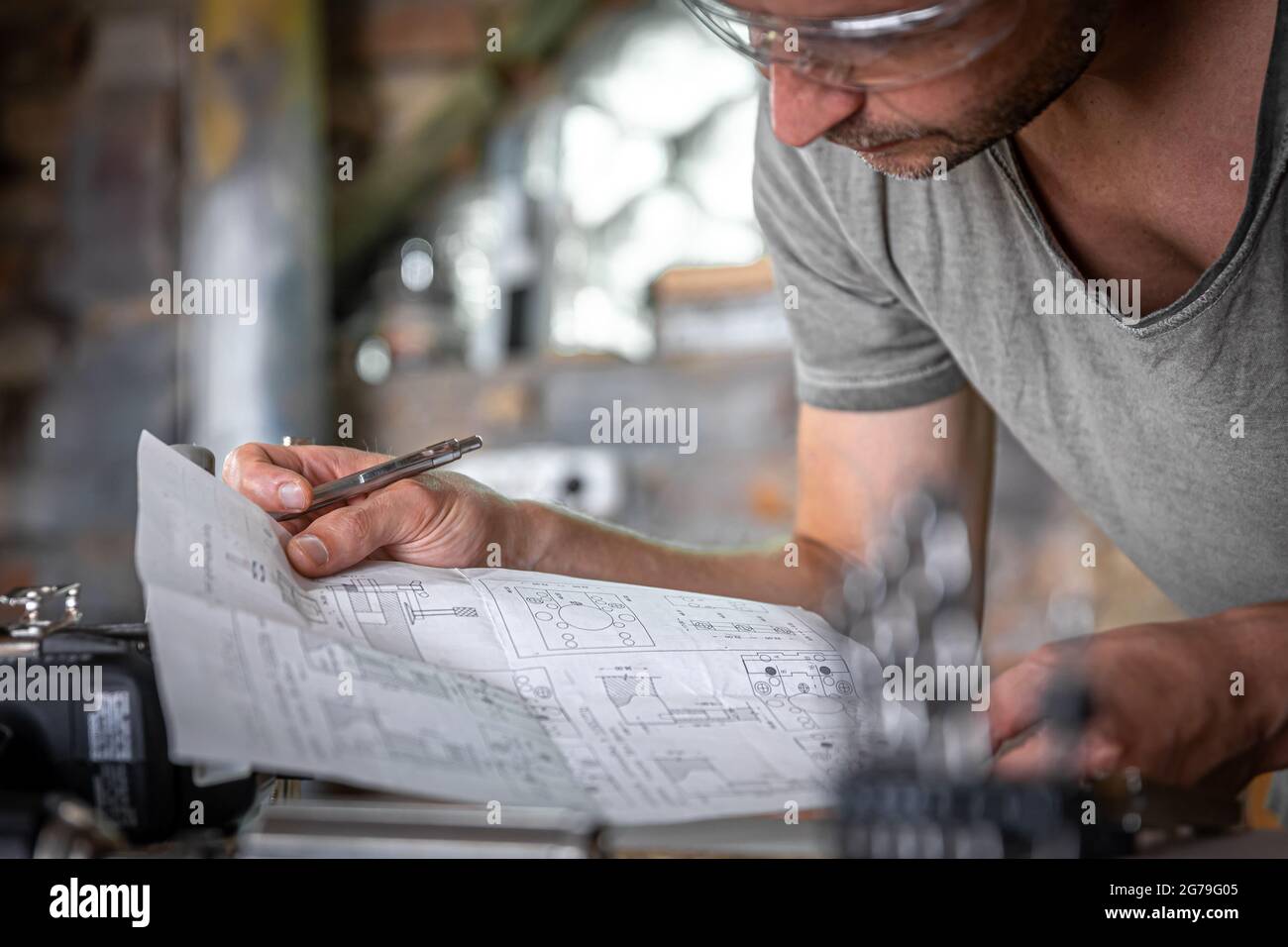 Male joiner in the process of working with wood in the workshop Stock ...