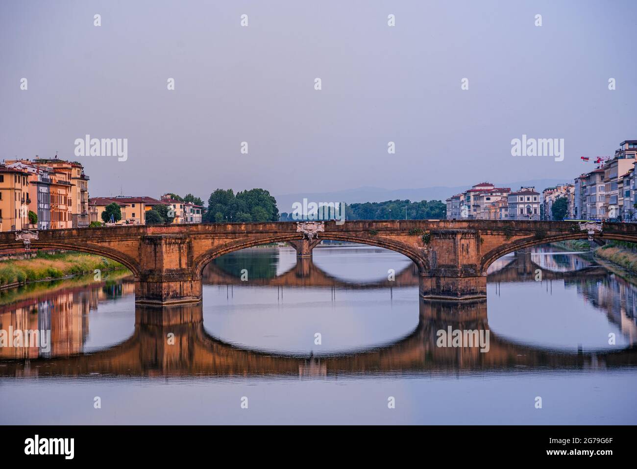 Two beautiful arch bridges reflecting in River arno, Florence, Italy ...