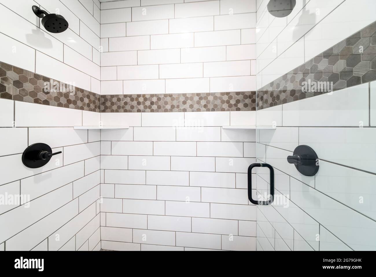 Shower stall with decorative tile walls outline and opened transparent ...
