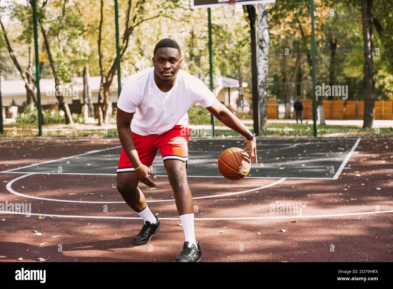 African American basketball player on an outdoor sports ground playing ...