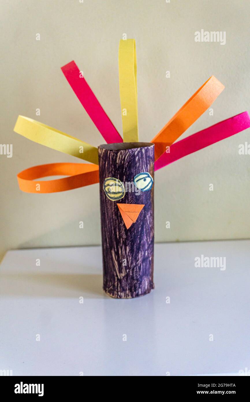 Child artwork representing a face, made with used toilet paper roll and ...