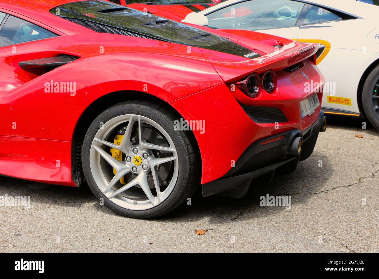 Close up of the rear wheel Red Ferrari F8 Tributo car parked at a Super ...