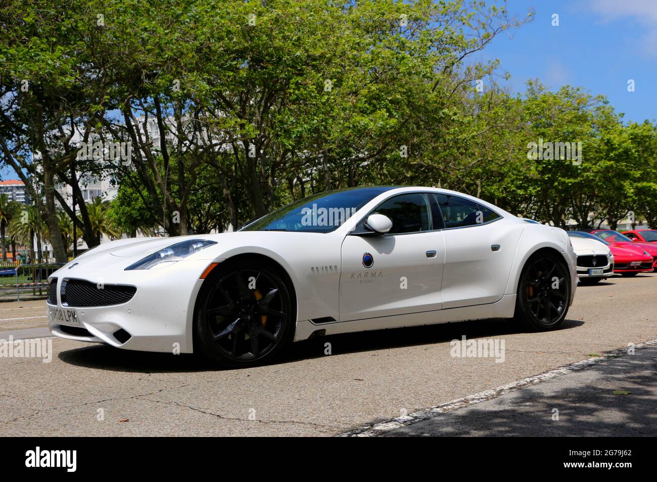 Side view of a white Karma Revero GT car parked at a Super car day ...