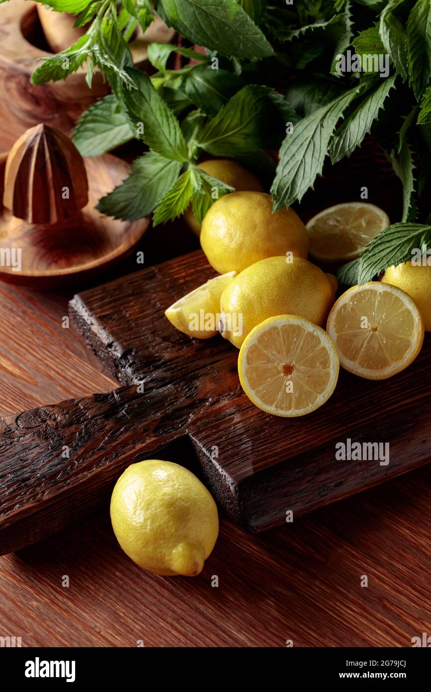Fresh juicy lemons with mint on the old wooden table Stock Photo - Alamy
