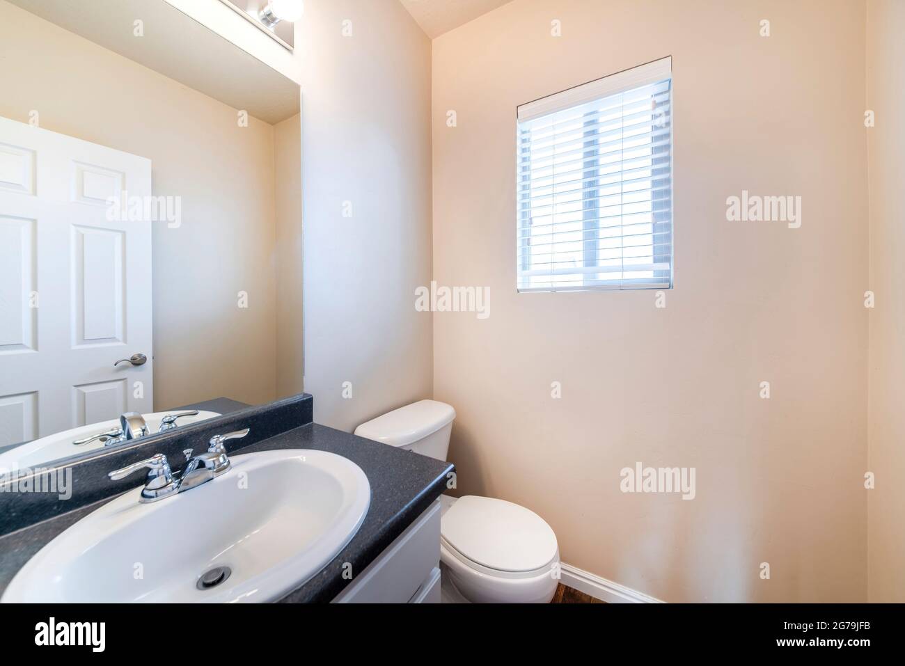 Powder room interior with black marble countertop and window Stock ...