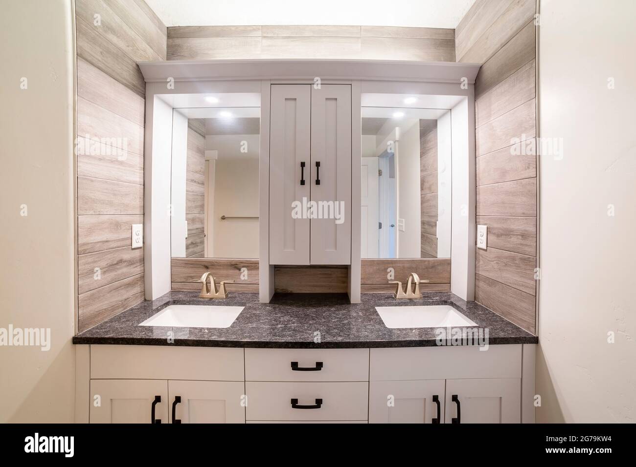 Alcove double vanity sink with wood panel walls and cabinet Stock Photo ...