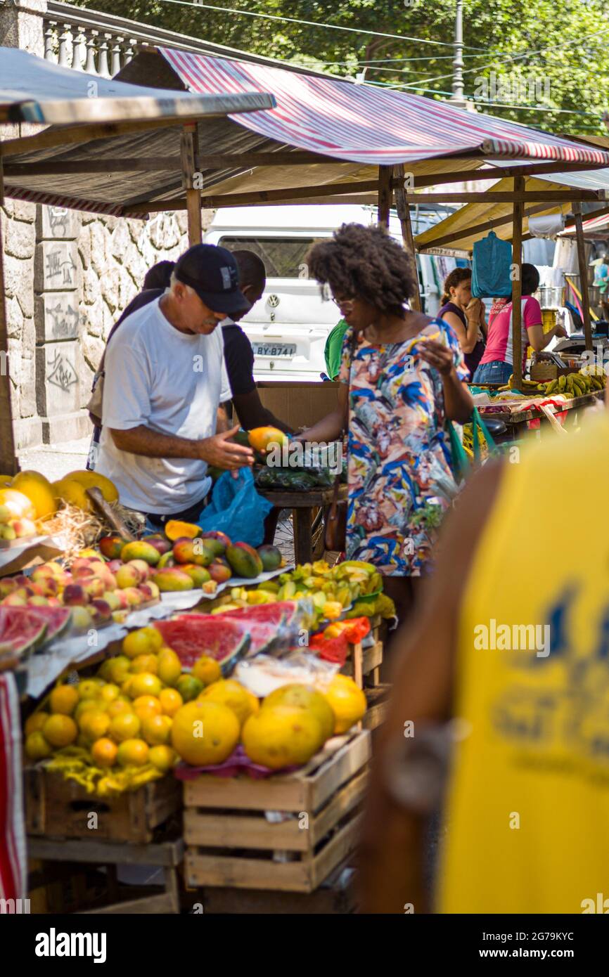 A brazilian woman and a street seller at the local market in Rio de ...