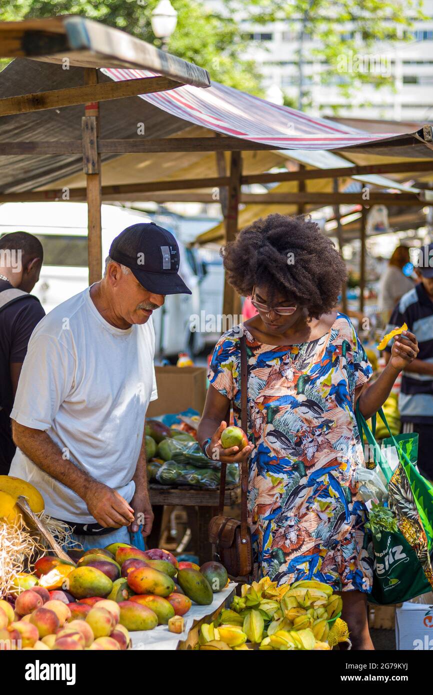 A brazilian woman and a street seller at the local market in Rio de ...