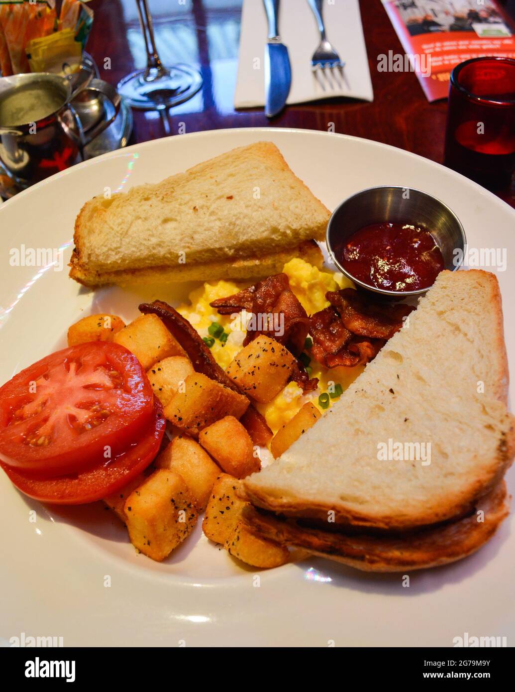 Breakfast with Toasted Bread, Scrambled eggs, and Tomato Stock Photo ...