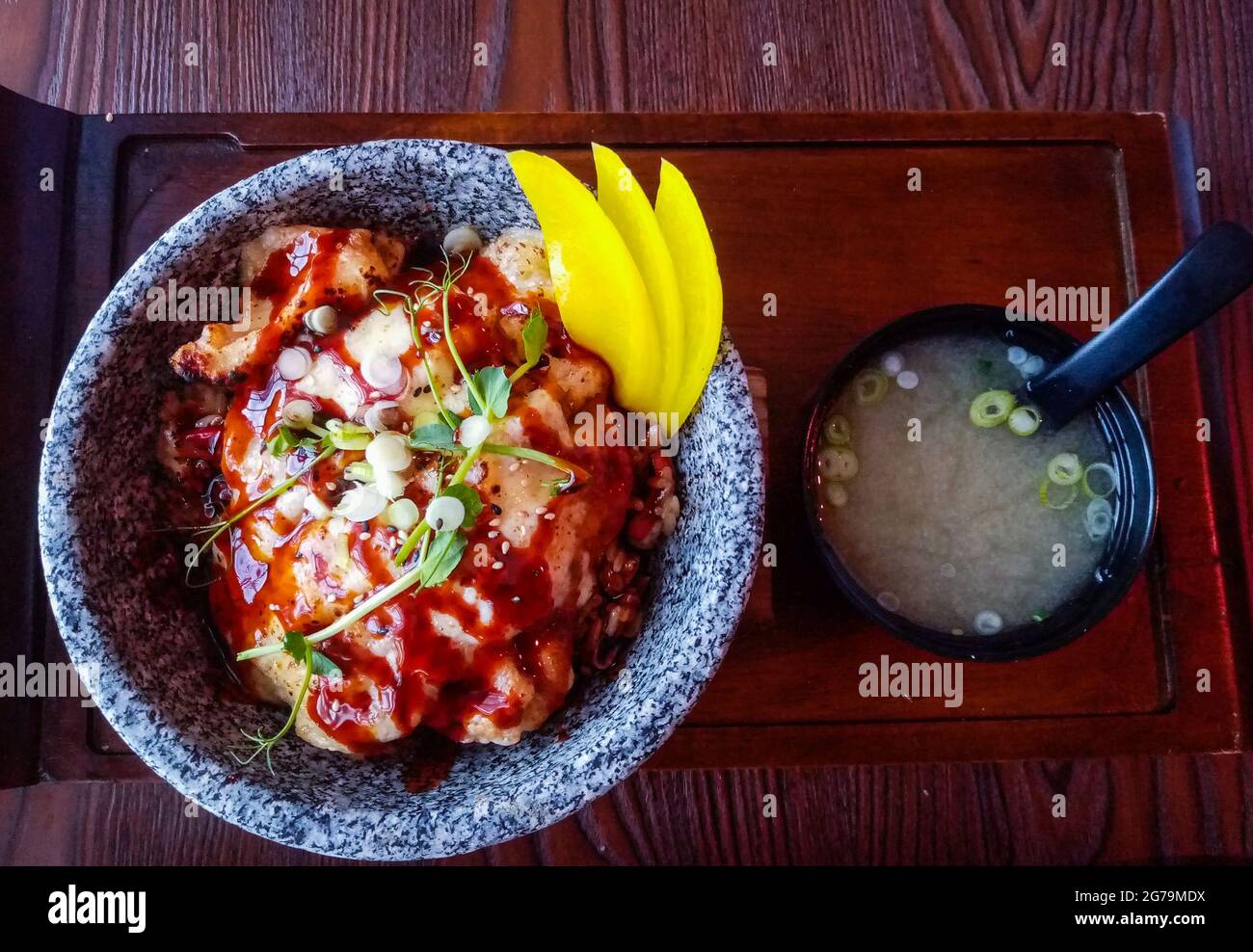 Top view of Japanese tori cheese don, grilled chicken on bed of rice ...