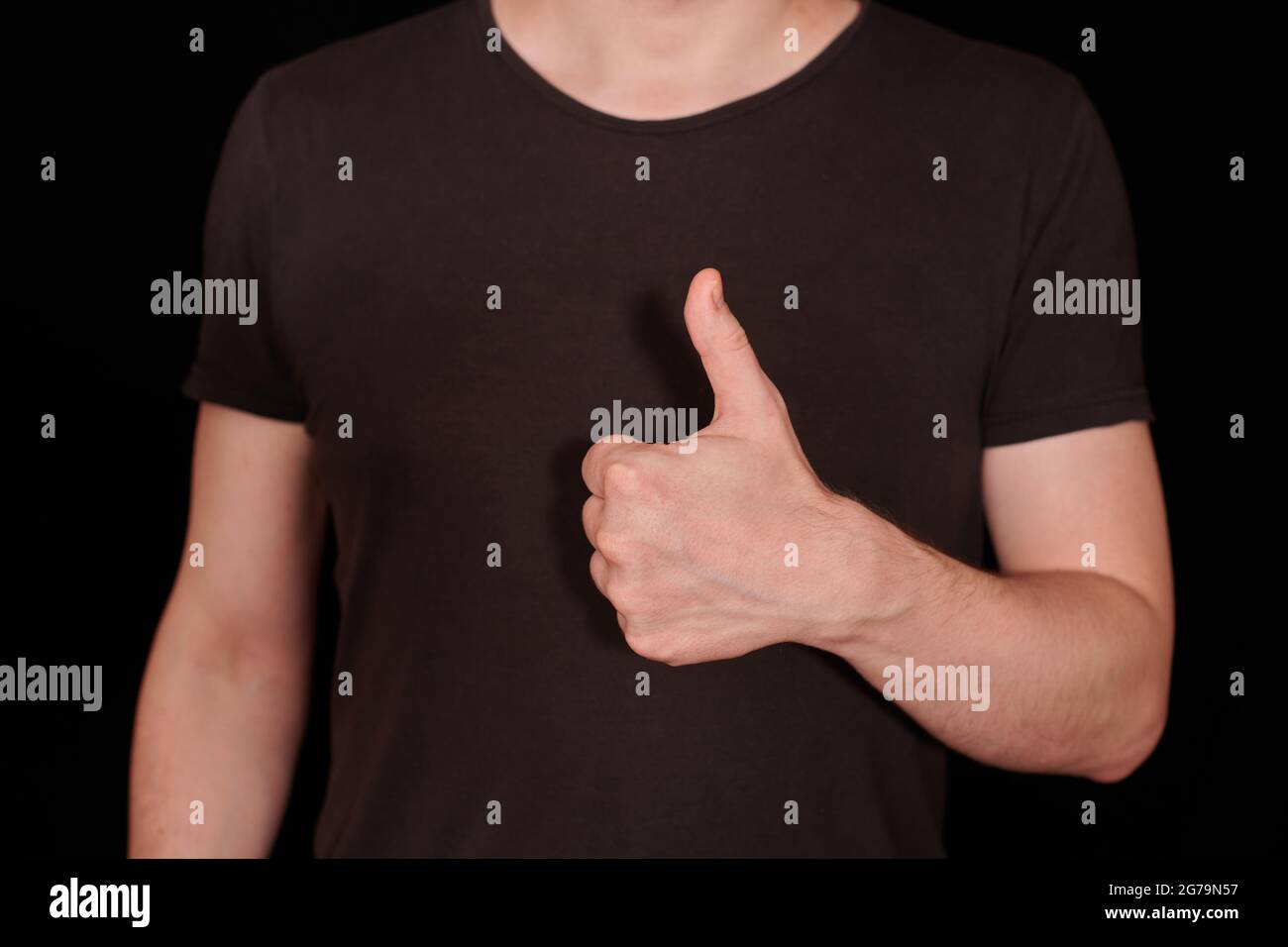 Thumbs up signal man hand gesture. Thumbs-up sign, black background ...