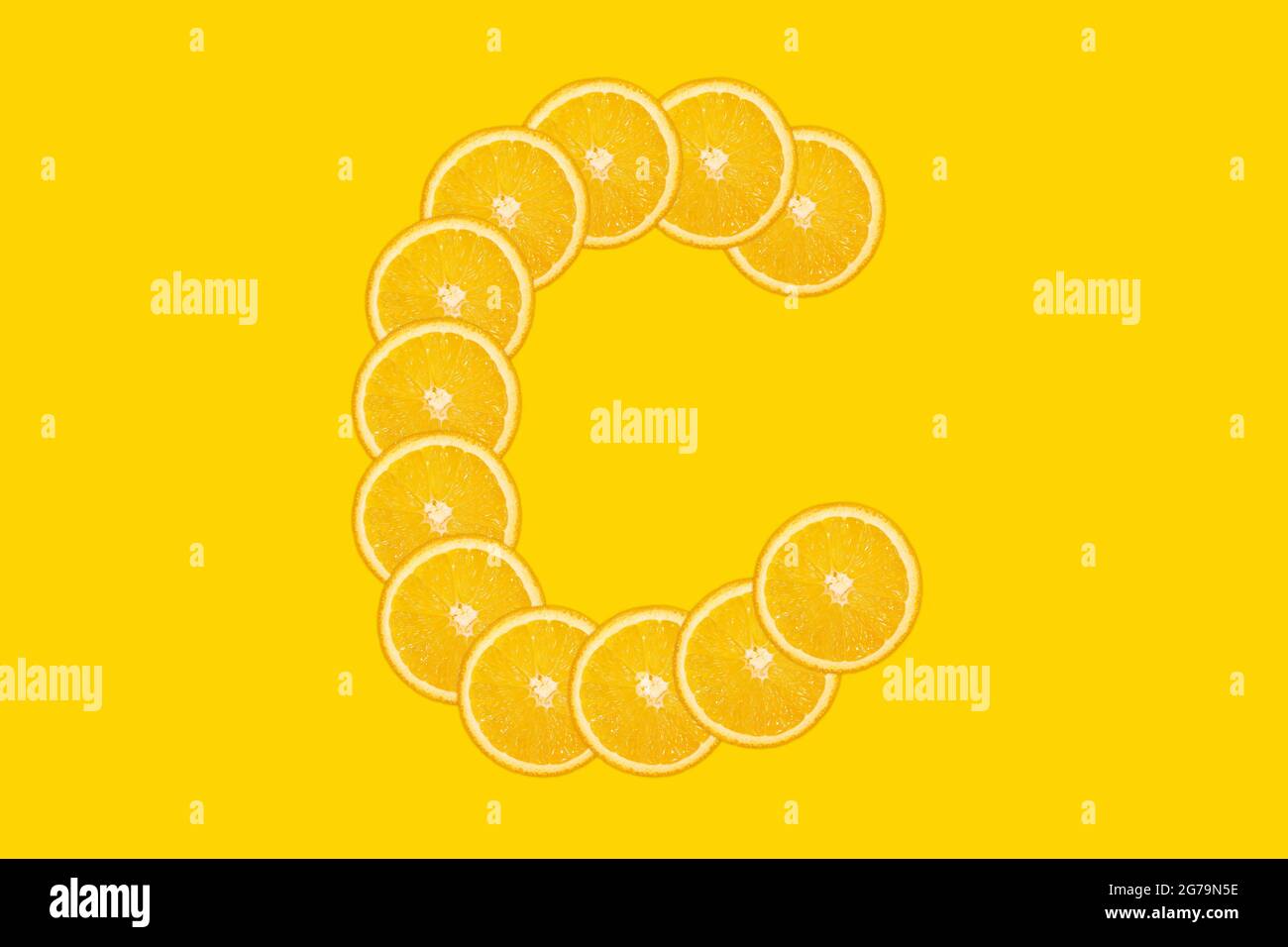 Sliced orange alphabet - letter C. Yellow background. Fresh healthy ...
