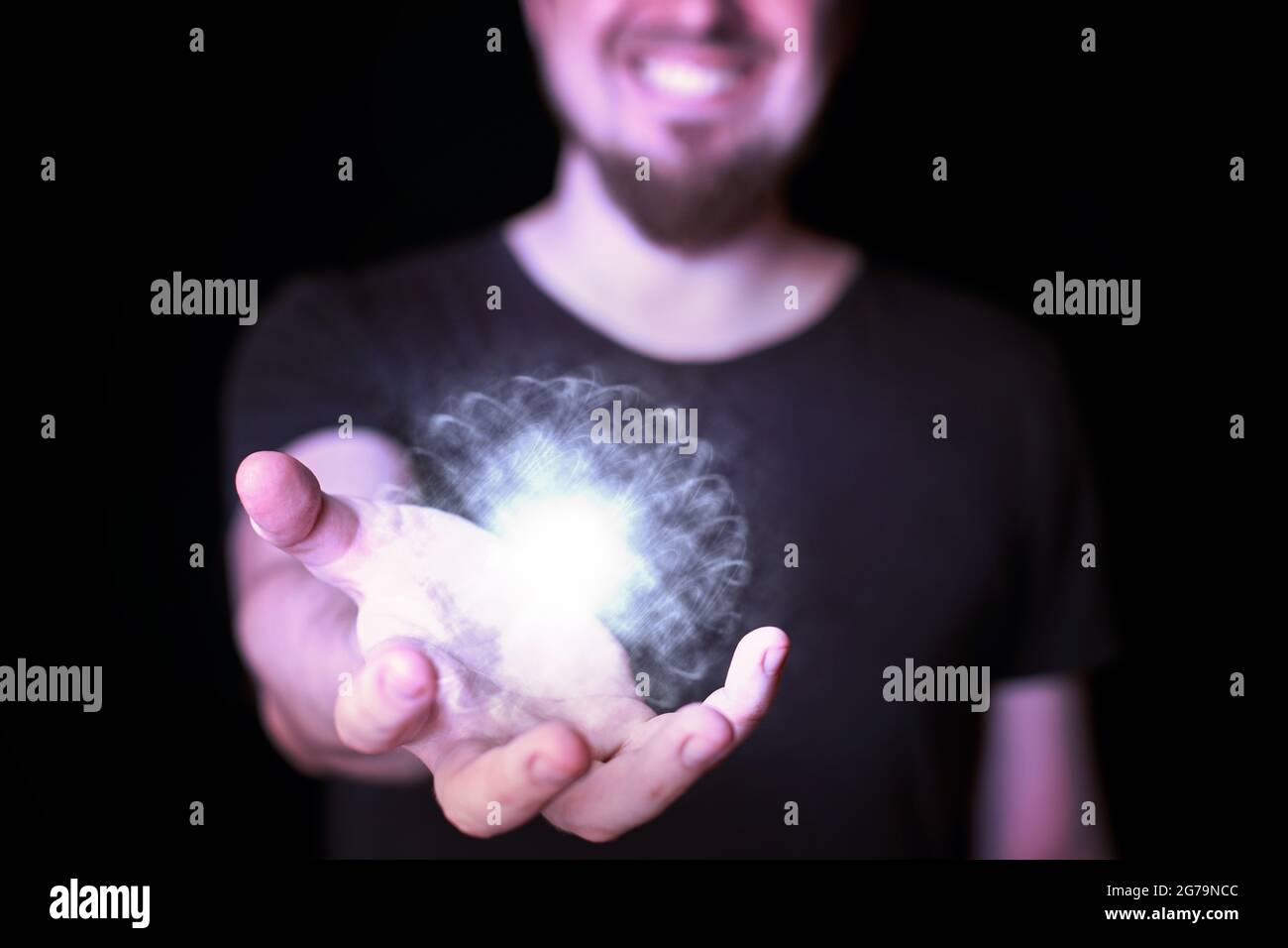 Energy ball in wizard hand. Bearded man casting bright magic ball spell ...