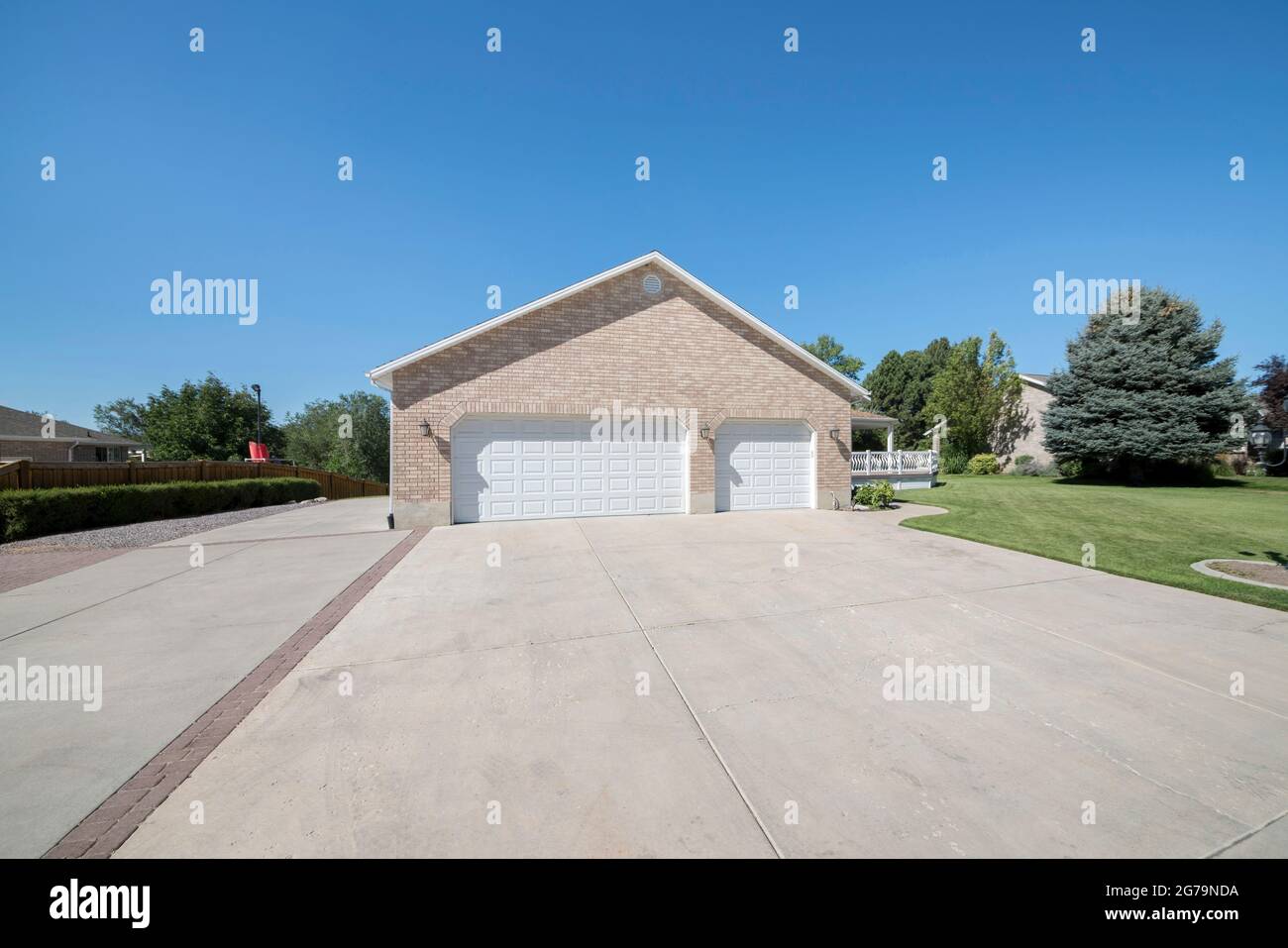 Double garage doors adjacent to each other with wall bricks and wall ...