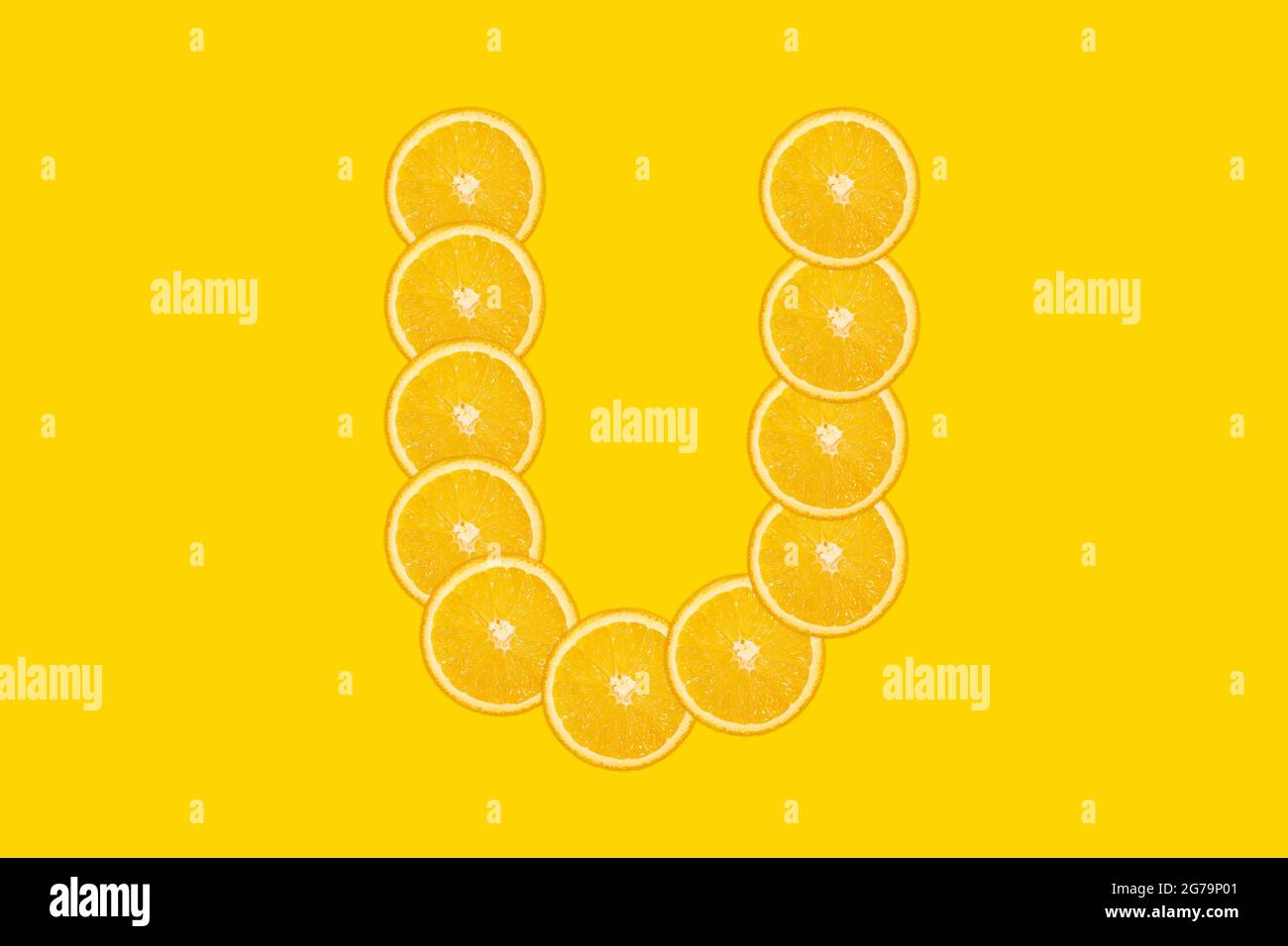 Sliced orange alphabet - letter U. Yellow background. Fresh healthy ...