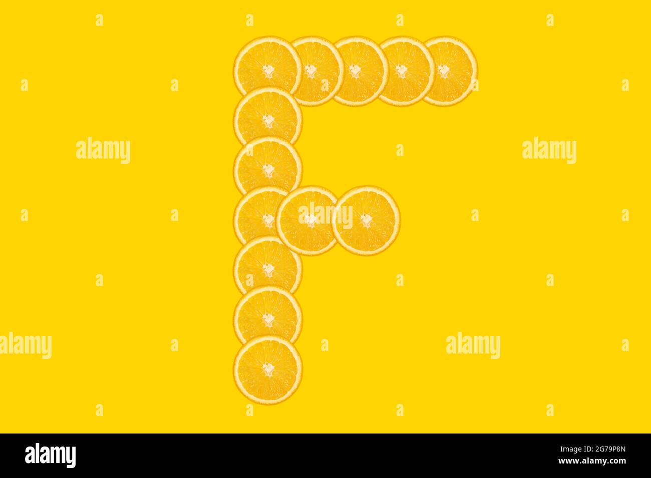 Sliced orange alphabet - letter F. Yellow background. Fresh healthy ...