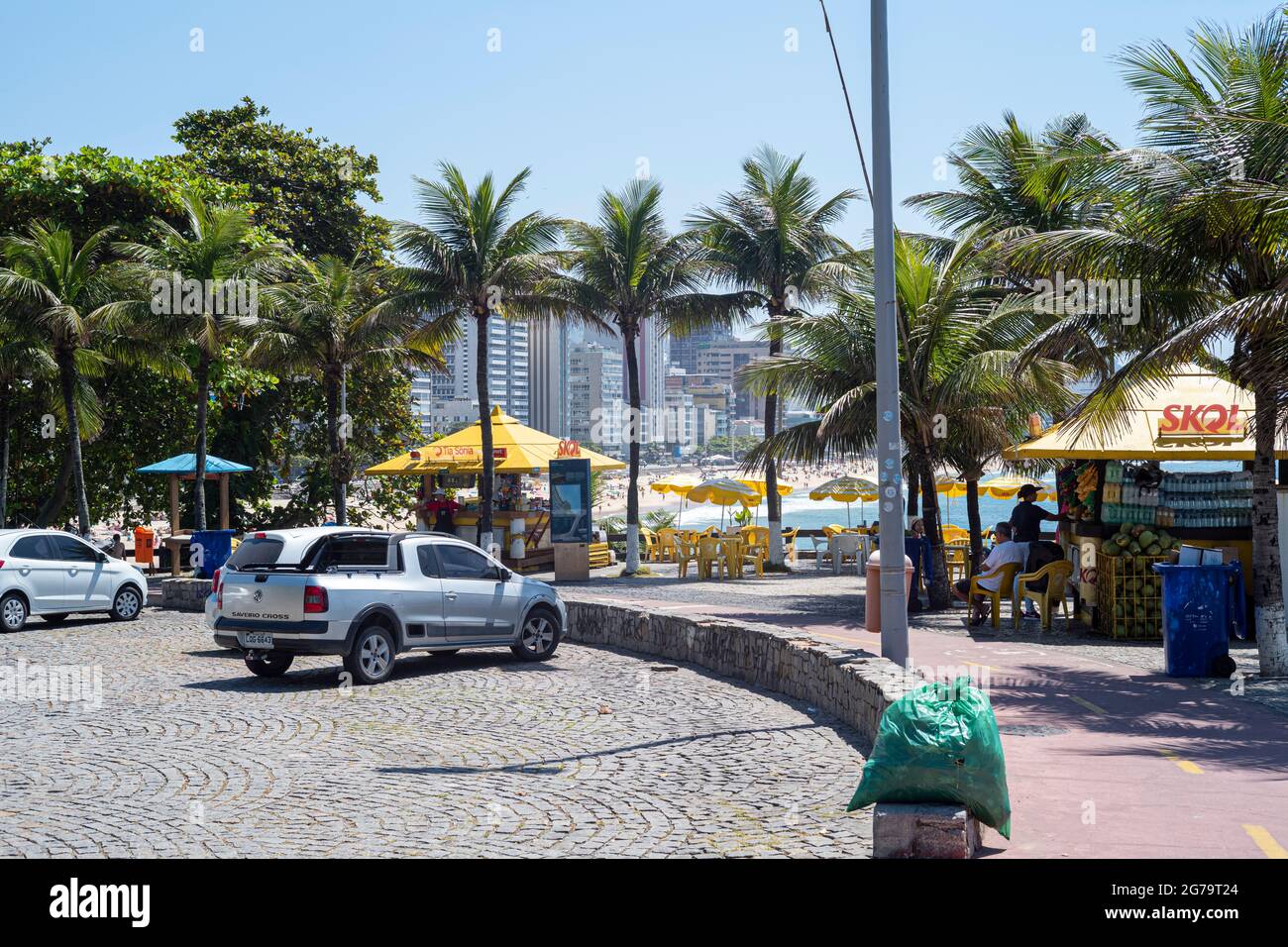 The beach of Leblon behind a outdoor cafe and a parking lot in Rio de ...