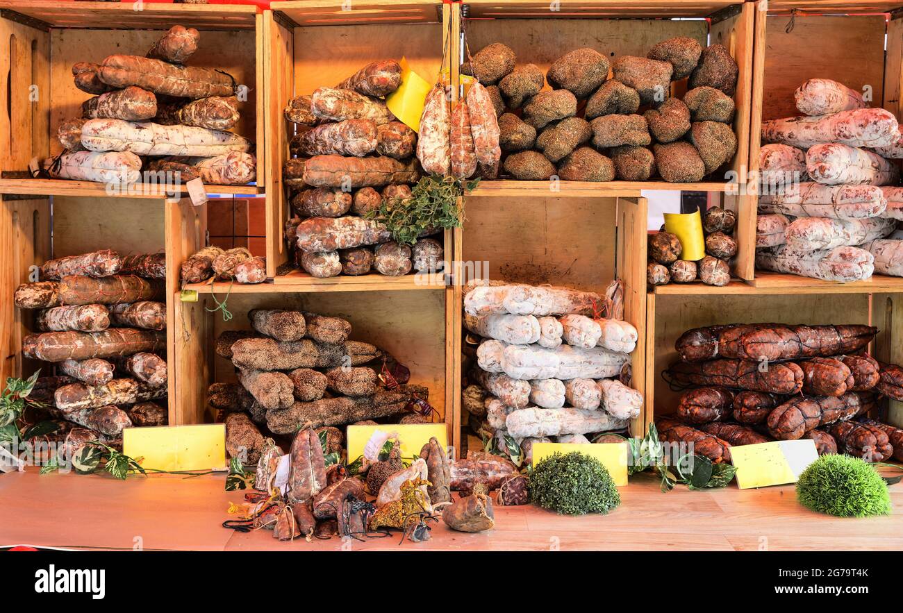 different types of meat in a butcher shop with sausages in various ...