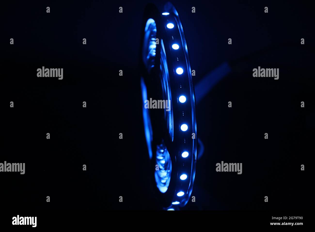 Blue glowing led strip isolated on dark background. Vertical strip of ...
