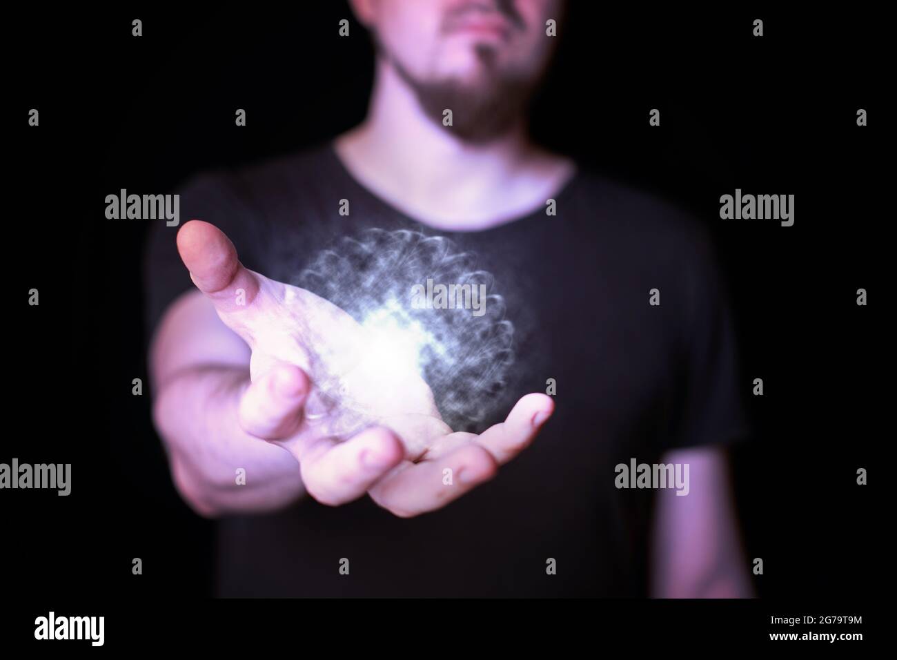 Energy ball in wizard hand. Bearded man casting bright magic ball spell ...