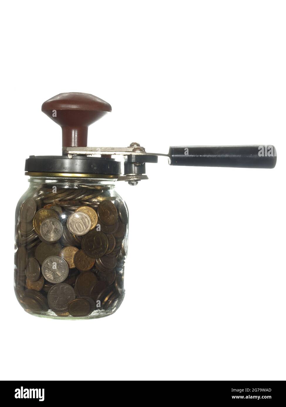 Canning jar with coins and seaming machine for canning isolated on ...