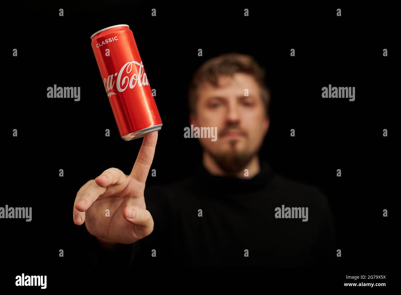 KALININGRAD, RUSSIA - MARCH 13, 2021 - Man with Coca Cola can on finger ...