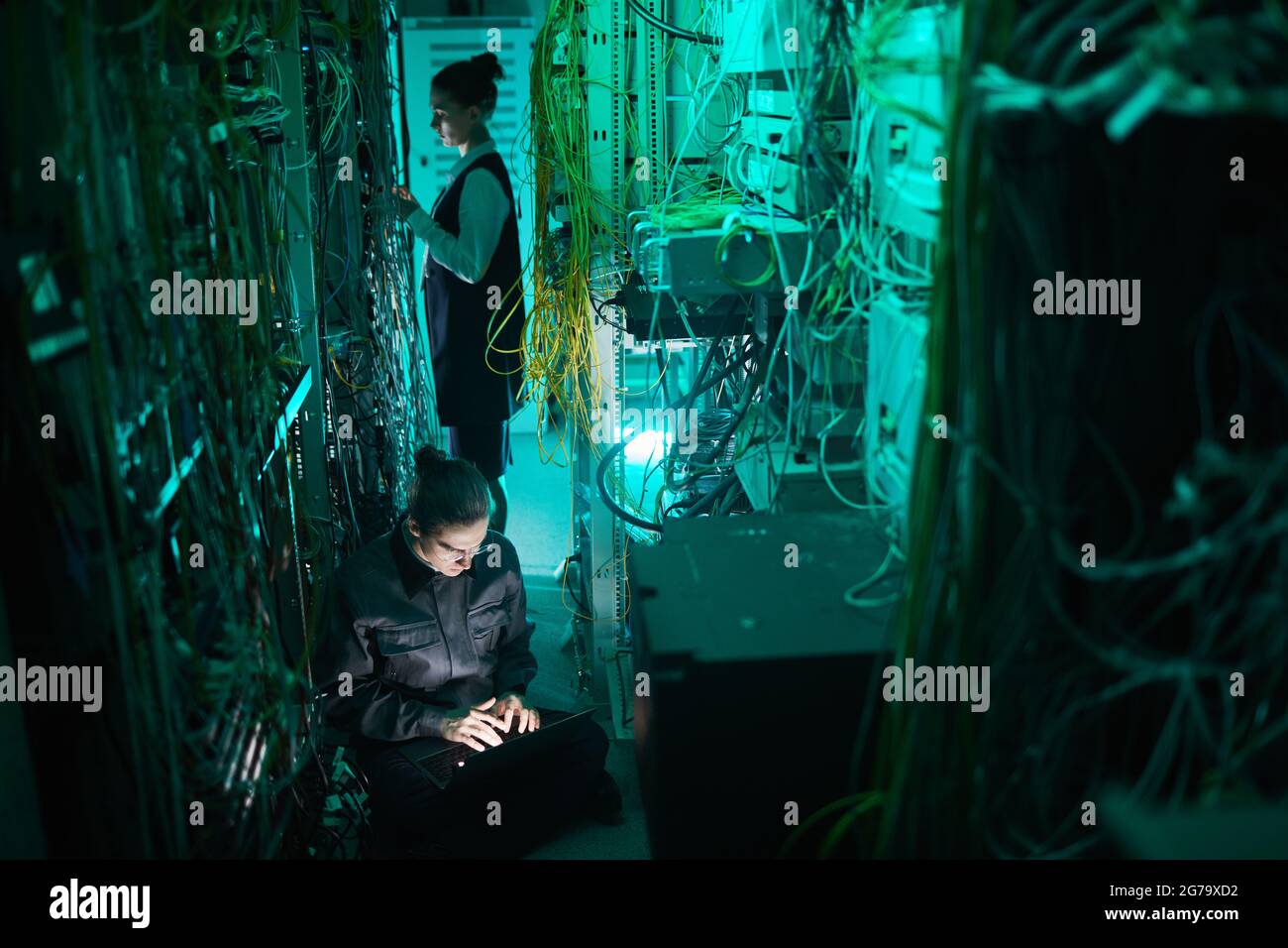 Portrait of young technician setting up computer network in server room, copy space Stock Photo ...
