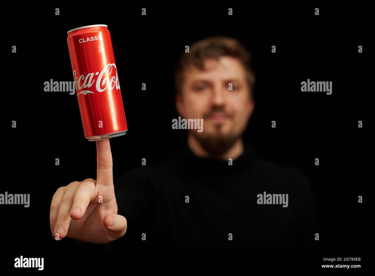 KALININGRAD, RUSSIA - MARCH 13, 2021 - Man with Coca Cola can on finger ...