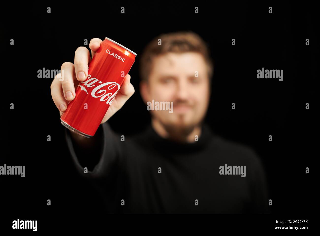 KALININGRAD, RUSSIA - MARCH 13, 2021 - Young guy with Coca Cola can in ...