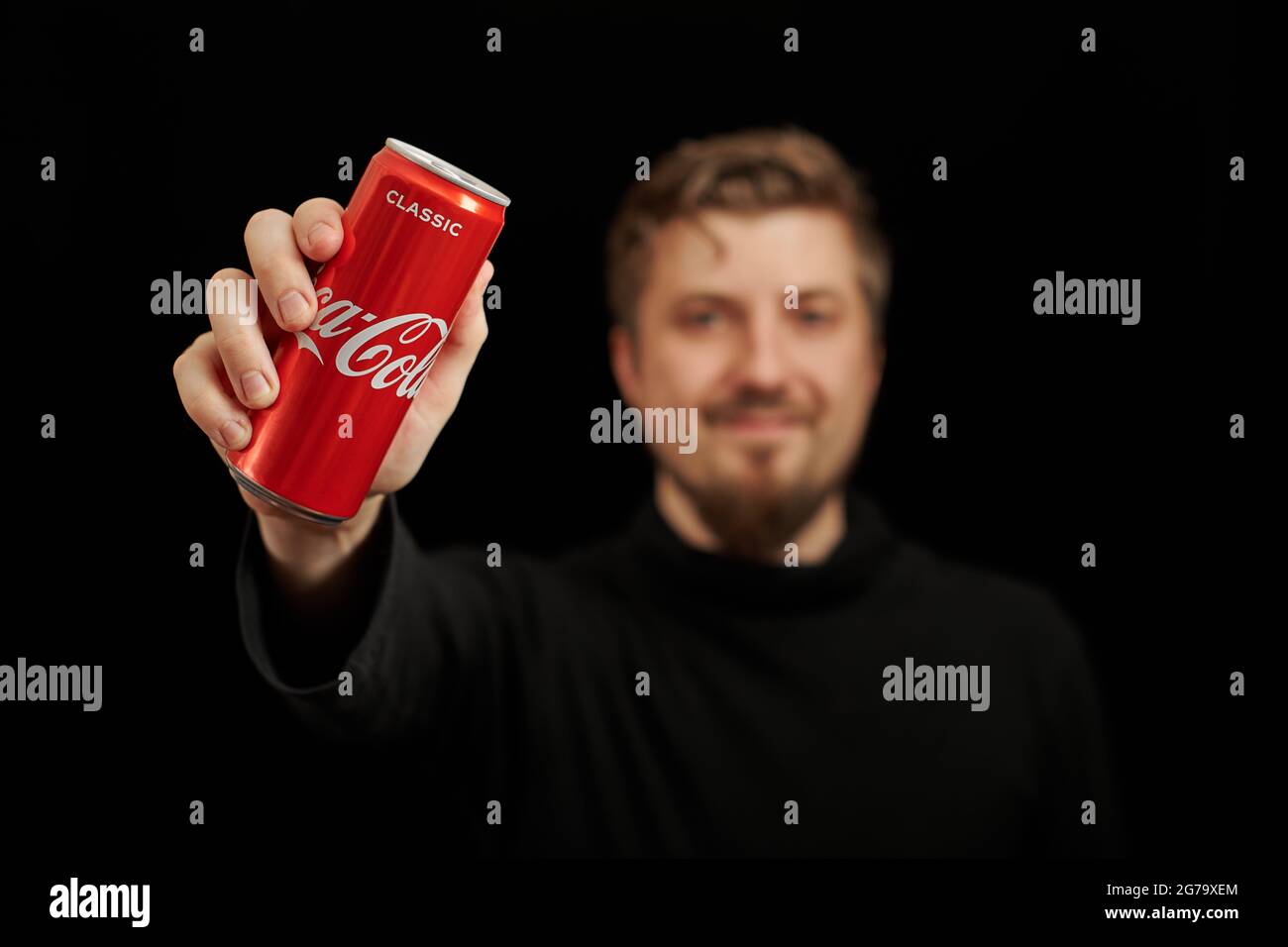 KALININGRAD, RUSSIA - MARCH 13, 2021 - Young guy with Coca Cola can in ...