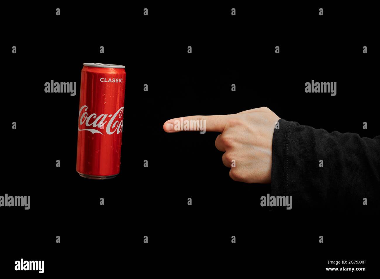 KALININGRAD, RUSSIA - MARCH 13, 2021 - Hand points to Coca Cola can ...