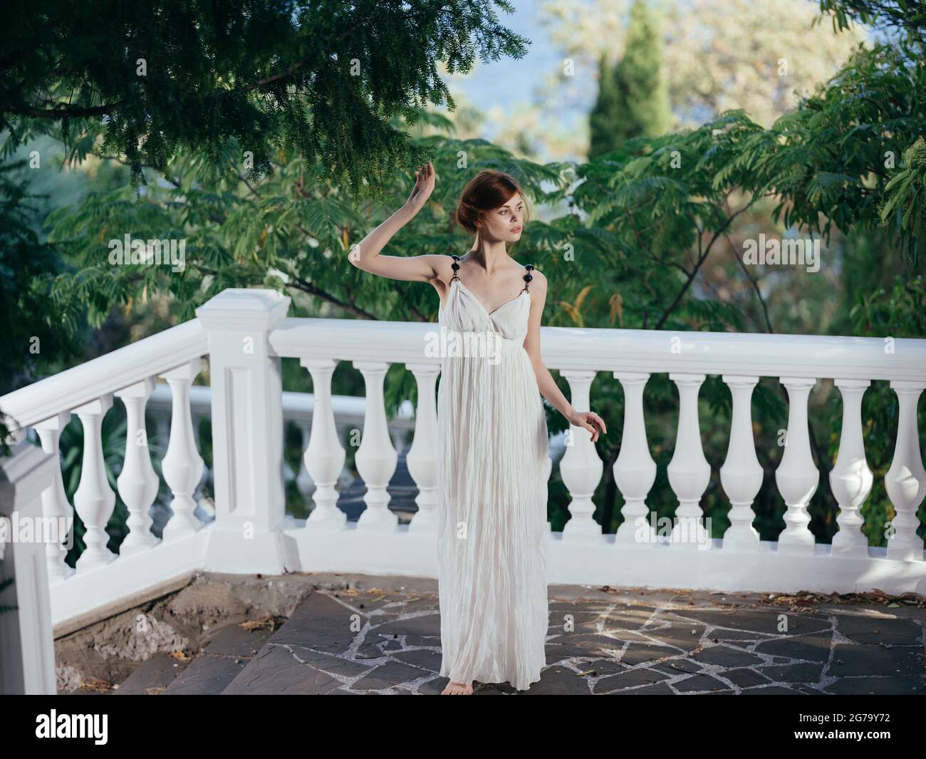 greek woman in white dress posing in the park Stock Photo - Alamy
