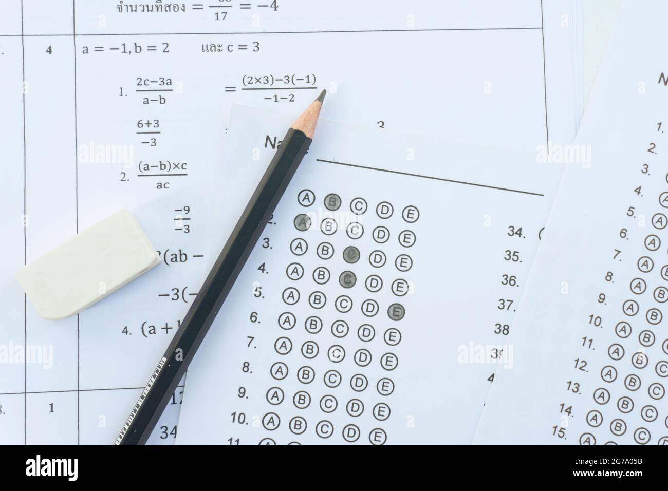 Pencil and eraser on answer sheets or Standardized test form with ...
