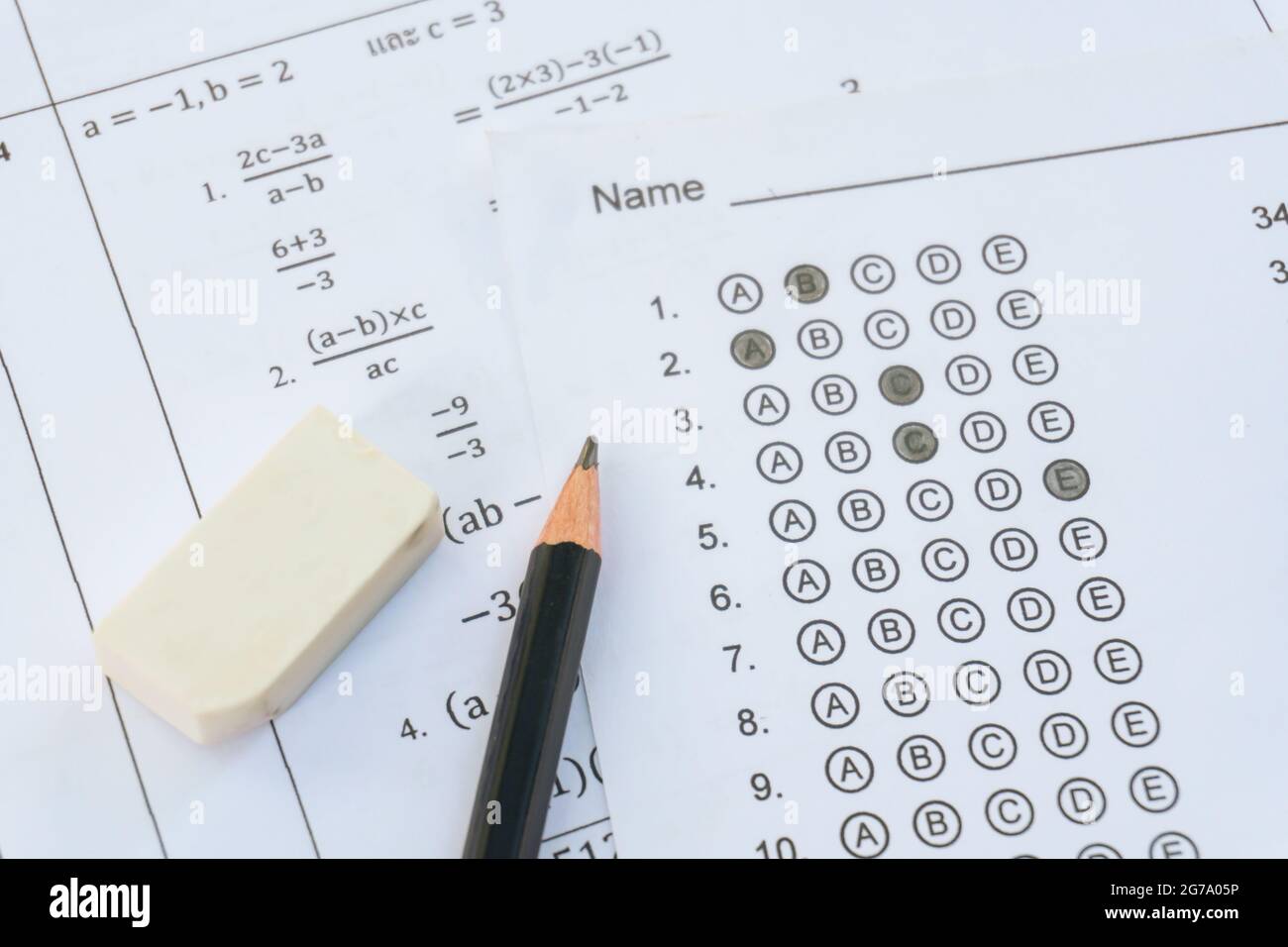 Pencil and eraser on answer sheets or Standardized test form with ...