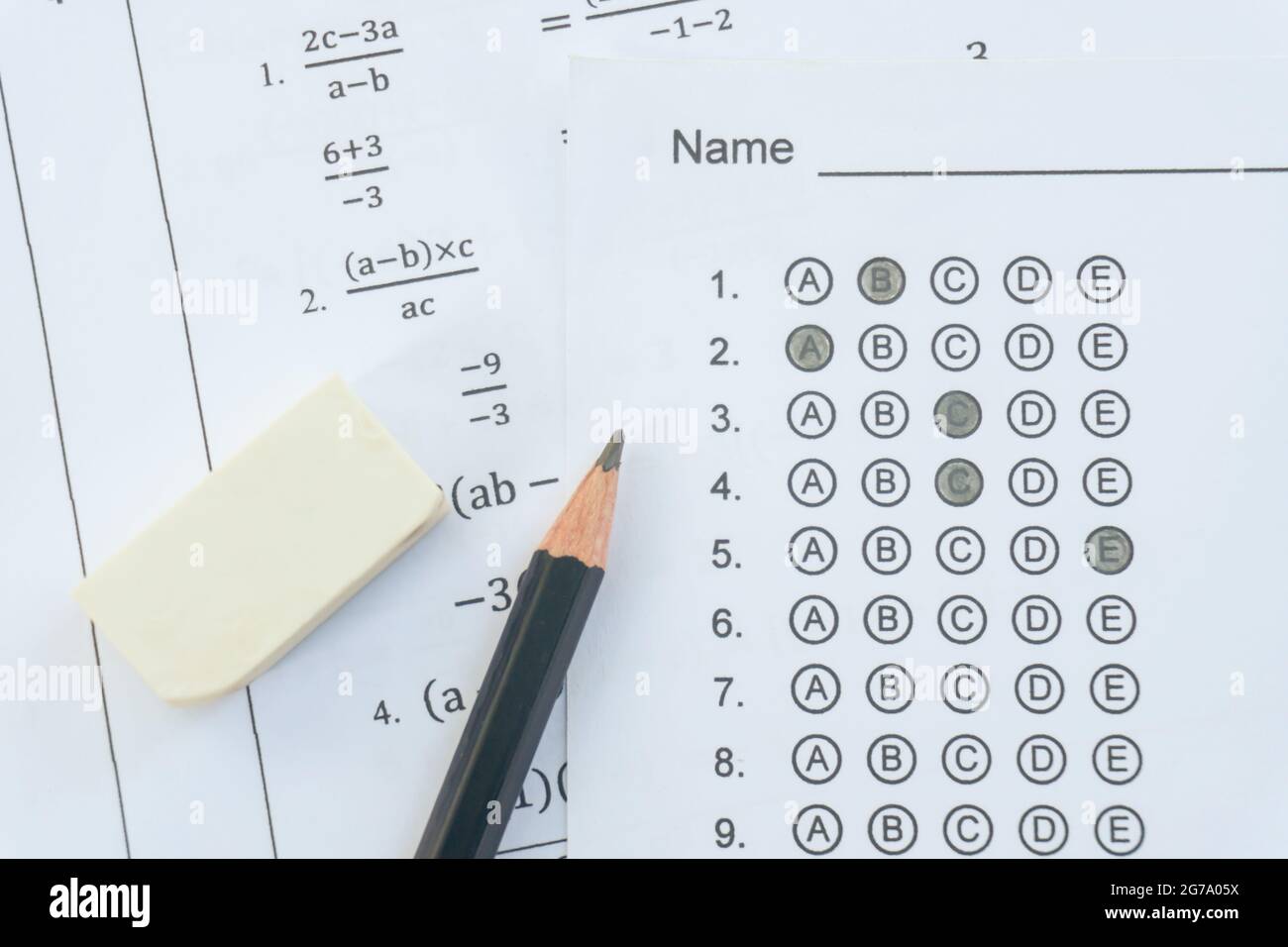 Pencil and eraser on answer sheets or Standardized test form with ...