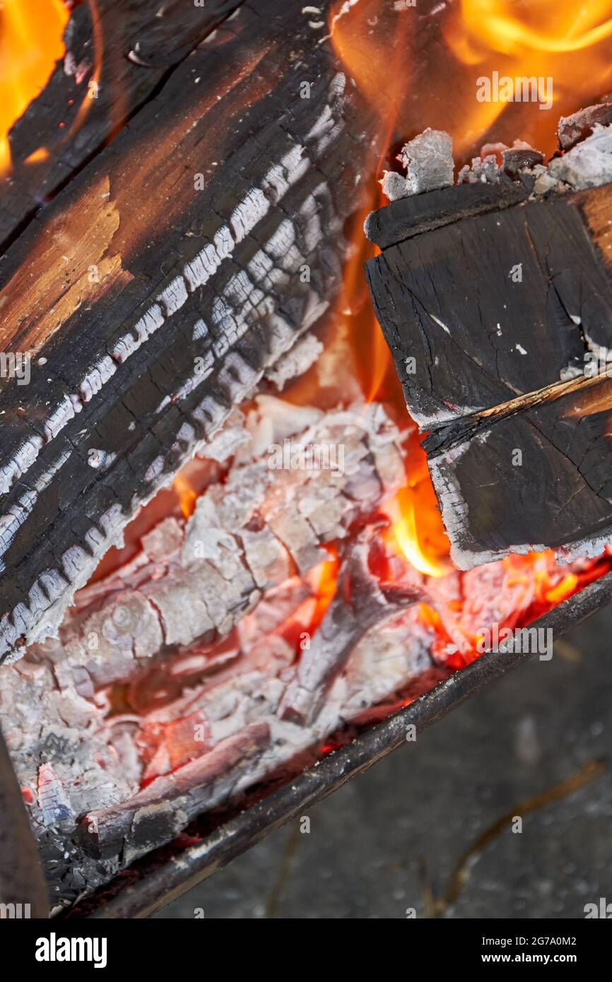 Vertical shot burning campfire coals with flame and smoke Stock Photo ...