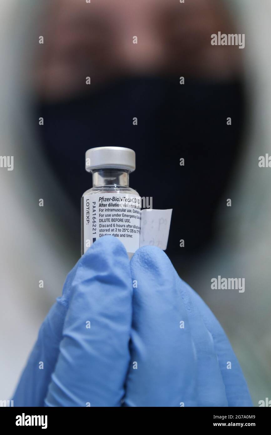 London, UK. 05th July, 2021. A NHS health worker holds a vial ...