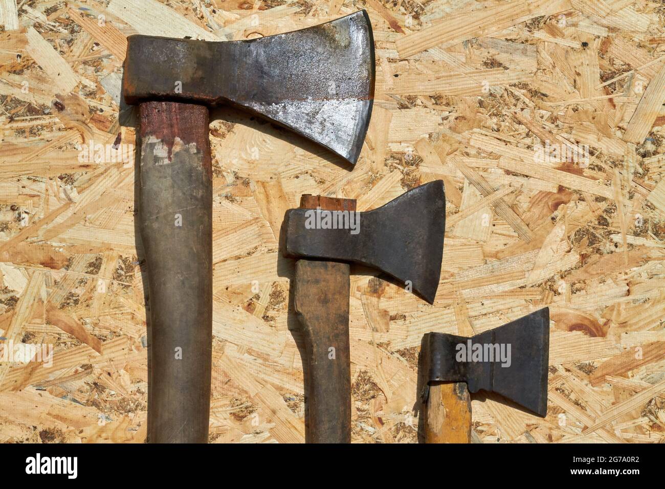 Set of work axes with wooden handle on plywood backgroud Stock Photo ...