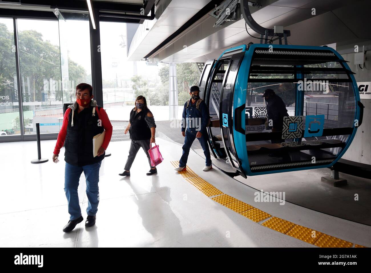 MEXICO CITY, MEXICO JULY 11: People board line 1 of the Cablebus while ...