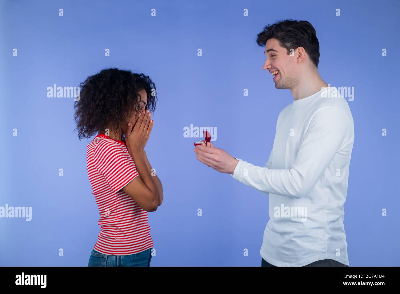 Young Interracial couple. Man makes marriage proposal to his lover ...